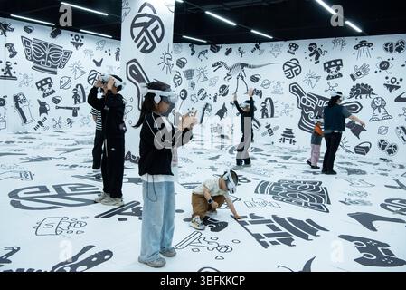 HAIAN, CHINA - JUNE 2, 2025 - Children are experiencing in a VR ...