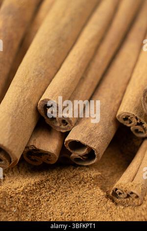 fragrant cinnamon sticks and ground spices on a wooden background Stock ...