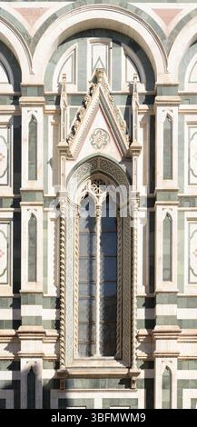 Gothic bifora window with twisted columns and lion relief on the marble ...