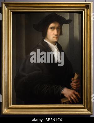 Young man holding figure of art dummy standing over isolated yellow ...