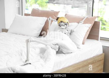 Human skeleton with sleeping mask lying in bedroom, top view Stock ...