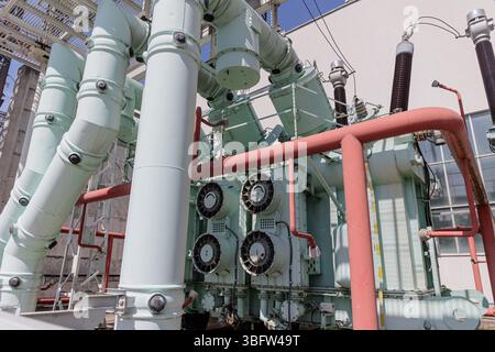 A photo of an electrical power substation transformer with cooling fans ...