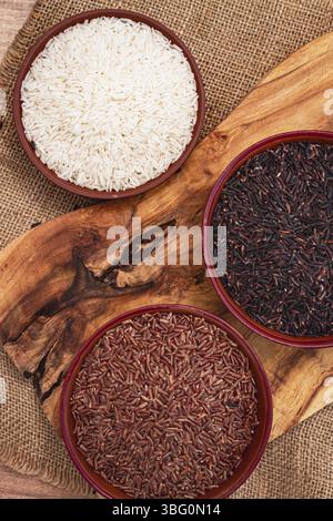 organic farming black rice in a paper bag packaging on a white table ...