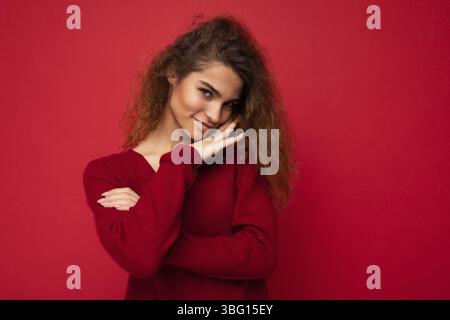 Young beautiful kind cute curly brunette woman with sincere emotions ...