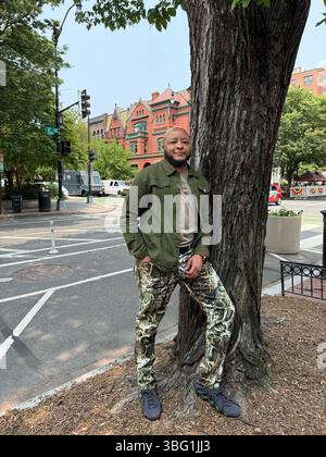 Washington, USA. 03rd June, 2025. Elijah Nicholas leans against a tree ...