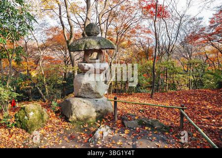 Stone tower and autumn maple at Arashiyama Jojakko-ji temple in Kyoto ...