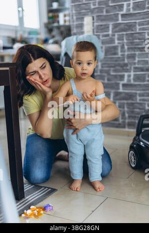 Angry mother scolding her son for breaking an egg in the kitchen ...