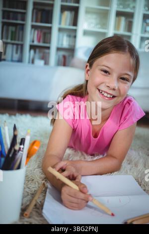 Girl drawing with colored pencil on a drawing board Stock Photo - Alamy