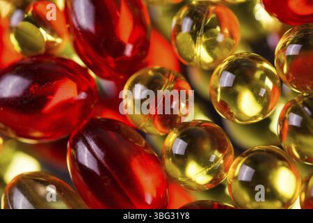 Yellow medical capsules on a mirror surface picture with depth of field ...