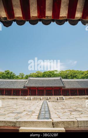 Korean traditional architecture with summer green trees at Jongmyo ...