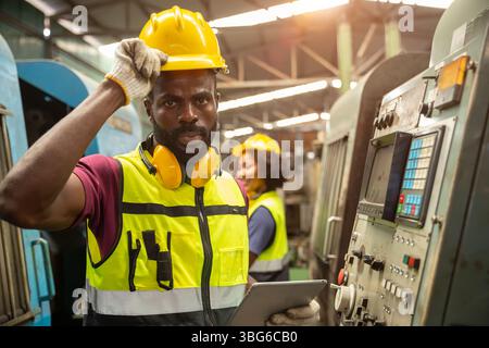 Portrait Of Black Machine Operator In Red Helmet, Hearing Protectors ...