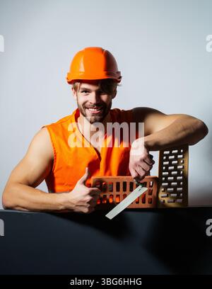 Crazy builder with bricks, funny sale on construction site. Funny man ...