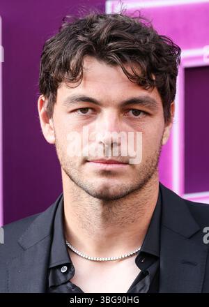 Taylor Harry Fritz of the United States returns a shot to Robin Haase ...