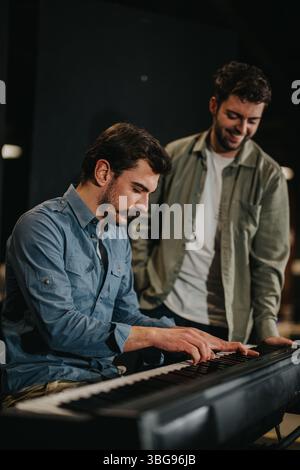 Musicians practicing collaborative keyboard performance in a ...