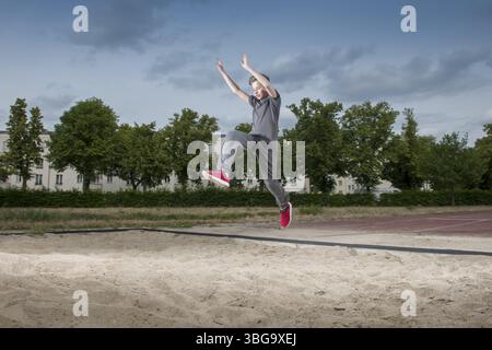 Side frontal full body view of a young male teenager frozen while ...