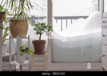 A huge pile of snow on a balcony through patio glass door with ...