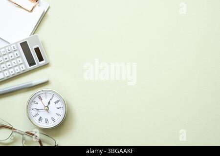 Mint calculator, eyeglasses, notebook and office supply on gray fabric ...