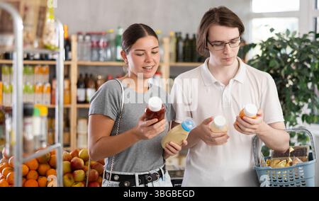 European youth girl choose and buy pizza with filling in store Stock ...