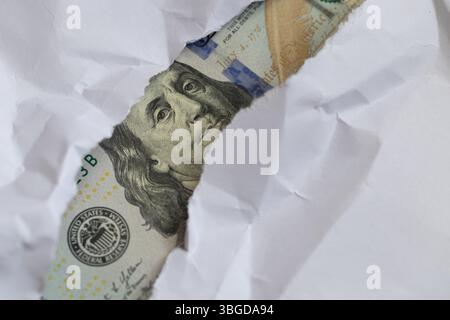 Benjamin Franklin macro peeking through torn white paper Stock Photo ...