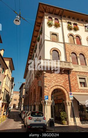Treviso, Italy 1 January 2025: Plants cascading from balconies add ...