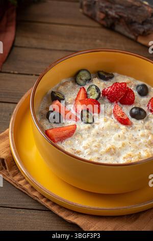 Delicious sweet healthy breakfast. Oatmeal with apples, bananas, honey ...