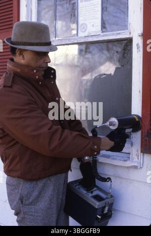 In 1982, a man uses a lead paint detector to measure potential lead ...