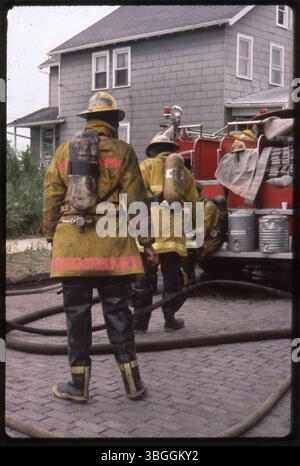 The firefighters standing around their truck at a station in Los ...