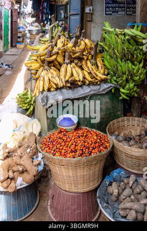 Plantains, yams, snails and red palm fruits at the central market in ...