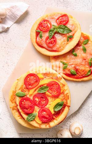 Board with different tasty mini pizzas on white background Stock Photo ...