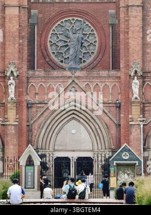 Tourists are taking a walk in Xujiahui Catholic Church Square in ...