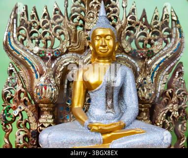 Gilded figure of Buddha on a throne Stock Photo - Alamy