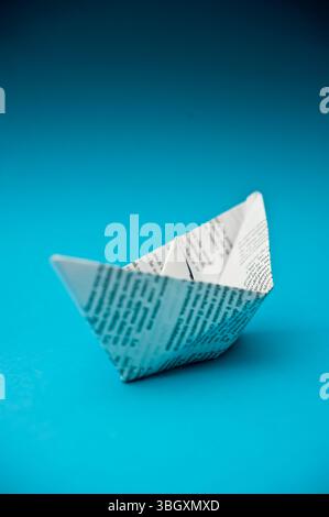 paper ship on blue background Stock Photo - Alamy
