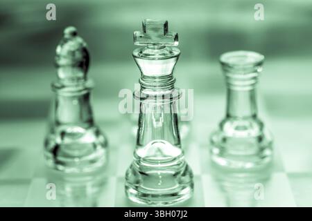 Chess with game pieces made of glass, queen, king, pawn and game board ...