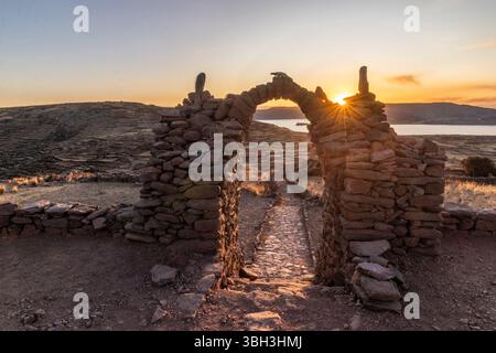 Sunset view of a stone gateway on Pachatata hill on Amantani island in ...