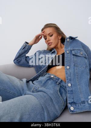 Stylish blonde woman showcases her denim fashion in a chic and modern ...