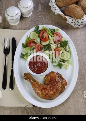 Baked chicken thigh with sauce and salad Stock Photo - Alamy