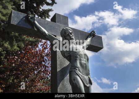 A statue of Jesus Christ crucified against unusual dramatic sky Stock Photo - Alamy