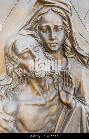 Bas-relief in bronze representing The Pity of Michelangelo. Faces of ...