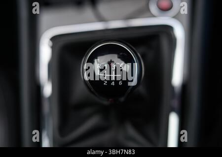 A gear shift with the numbers 1, 2, 3, 4, and 5 on it. The gear shift ...