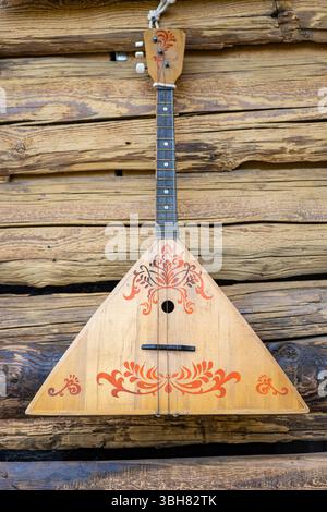 Folk musical instrument balalaika on wooden background Stock Photo - Alamy