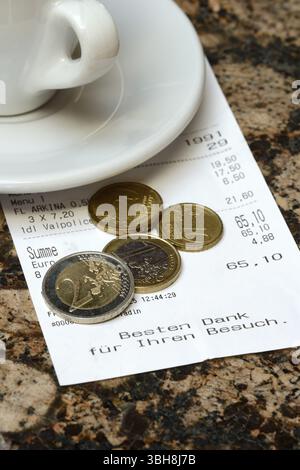 Tip, euro coins with receipt Stock Photo - Alamy