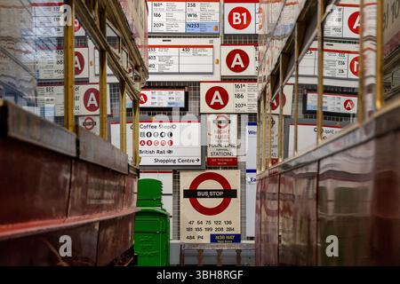 Collection of bus signage between two tram cars at the London Transport ...
