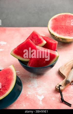 A top view of halved watermelon and slices on sitting baby's feet Stock ...