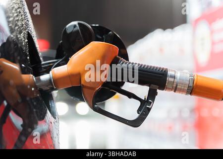 Orange and black oil nozzle Stock Photo - Alamy