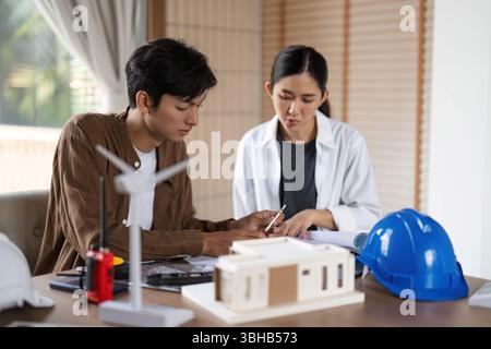 ESG Principles in Action. Young architects collaborating on sustainable ...