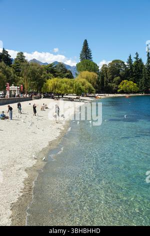 Queenstown Bay Beach with Queenstown Gardens and Lake Whakatipu on a ...