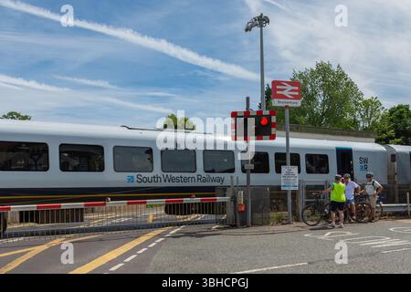Lymington Road, Brockenhurst, UK - May 31st 2025: Train crossing the ...