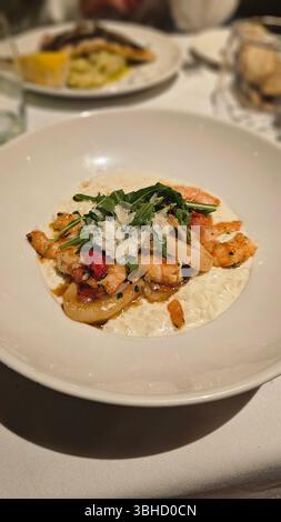 Italian Risotto with seafood, grilled prawns, mussels in a shell ...