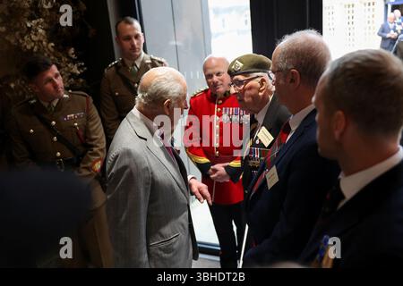 King Charles III talks with 101-year-old veteran Richard Brock during a ...