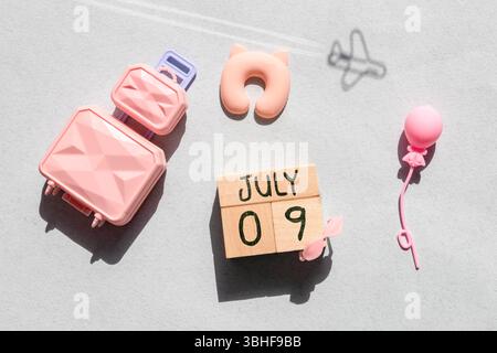 Female Hand holding wooden block calendar with the date July 24 on ...